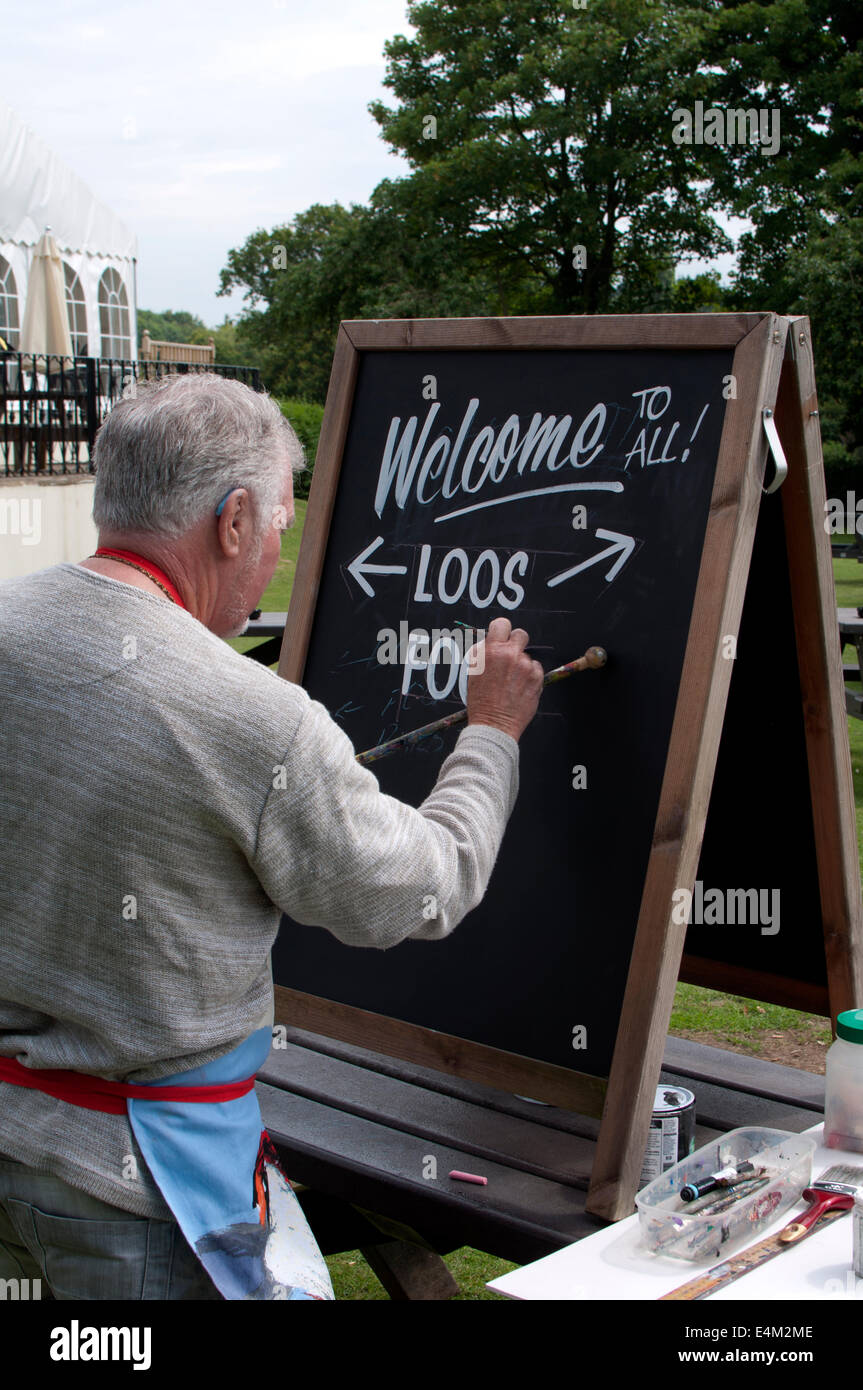 Signwriter making a sign Stock Photo - Alamy