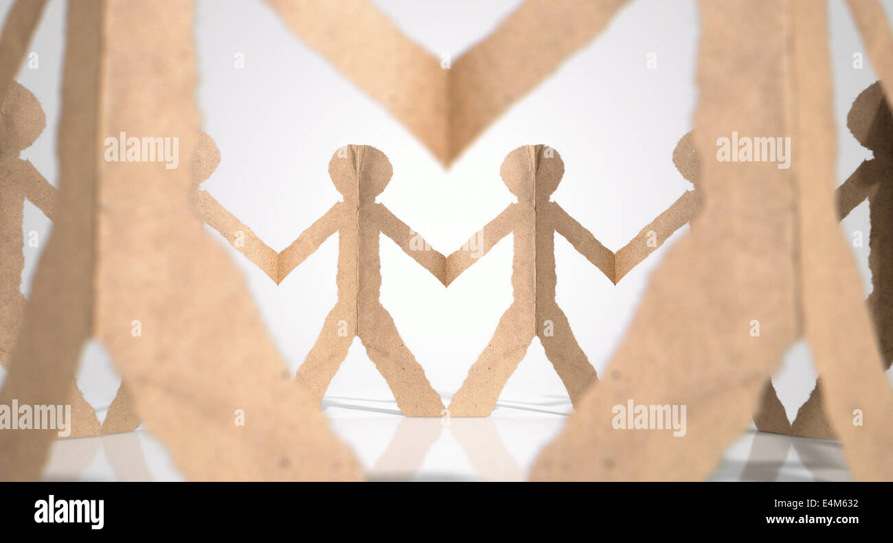 A circle of brown cardboard cutout men on an isolated white studio ...