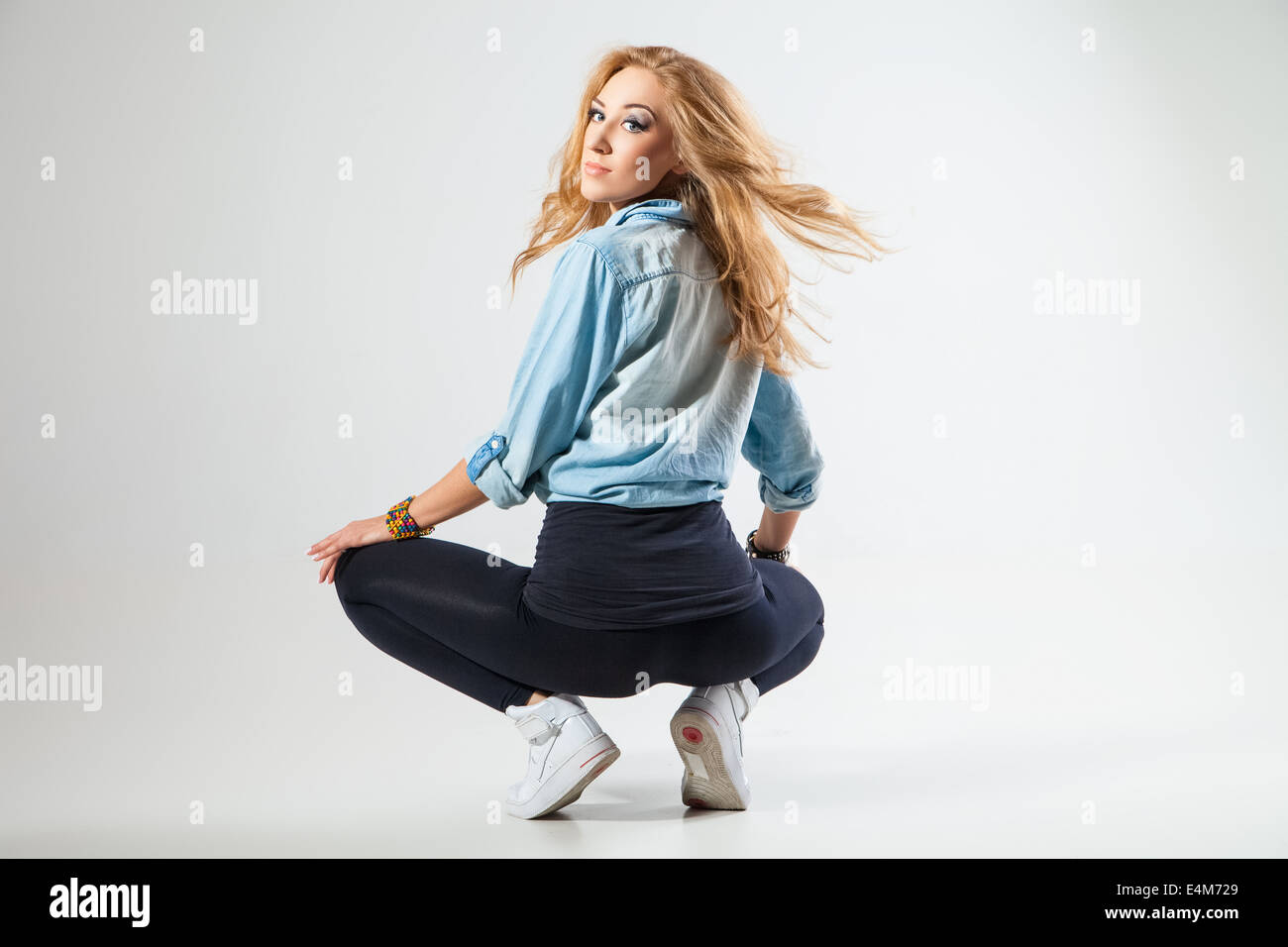 Modern dancer poses in front of studio background Stock Photo - Alamy