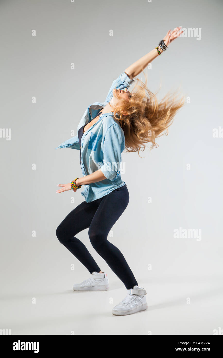 Modern dancer poses in front of studio background Stock Photo - Alamy