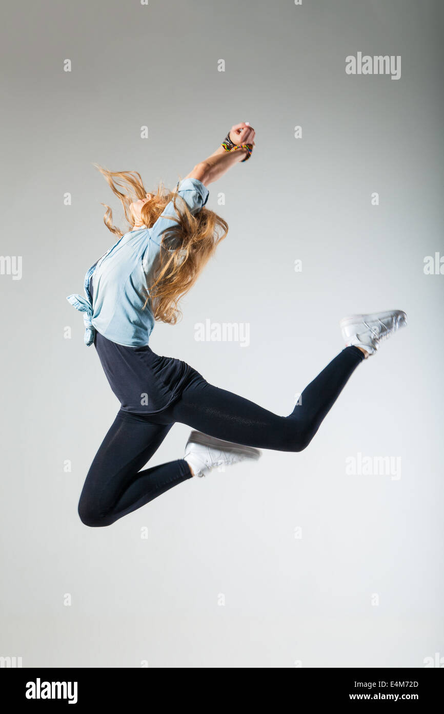 Modern dancer poses in front of studio background Stock Photo - Alamy