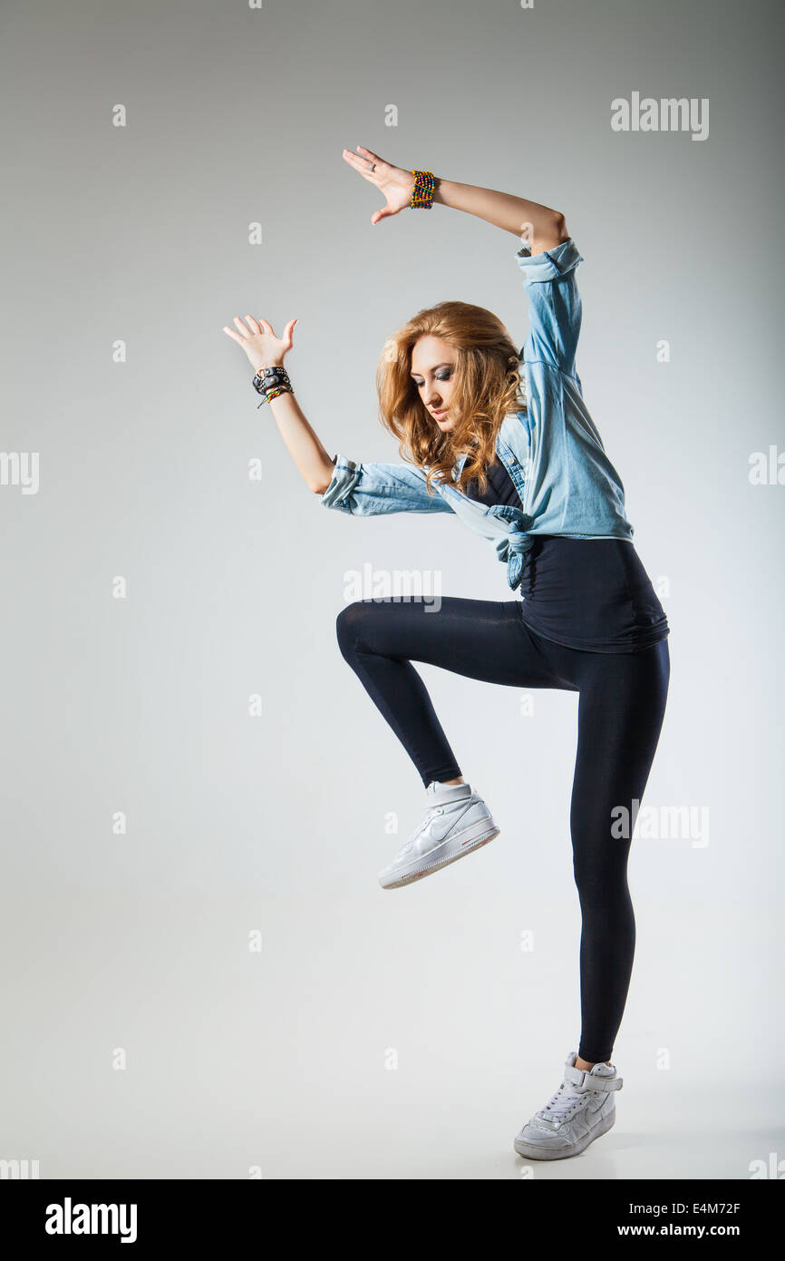 Modern dancer poses in front of studio background Stock Photo - Alamy