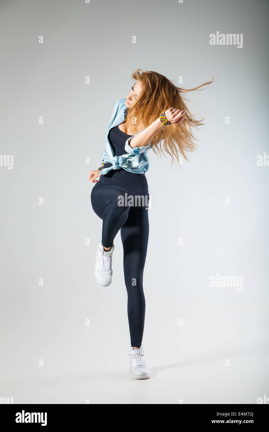 Modern dancer poses in front of studio background Stock Photo - Alamy