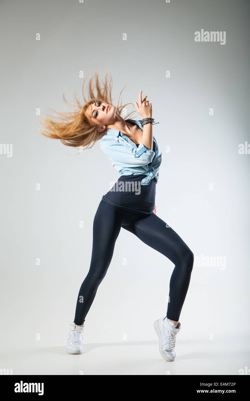 Modern dancer poses in front of studio background Stock Photo - Alamy