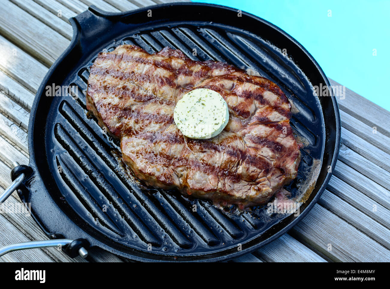 barbecue grilled steak with garlic butter at the swimming pool party ...