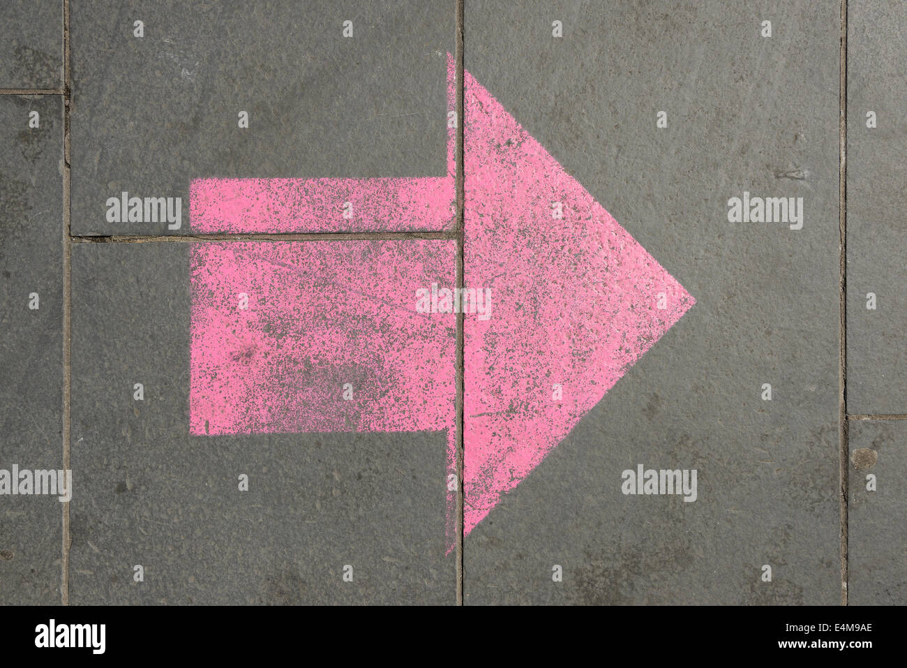 Arrow shape painted onto the pavement Stock Photo - Alamy