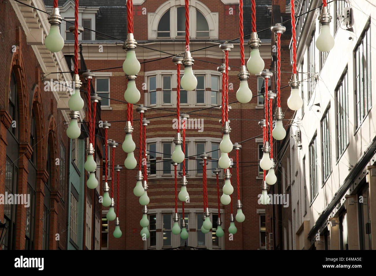 A decorative display of large light bulbs dangling above the ...