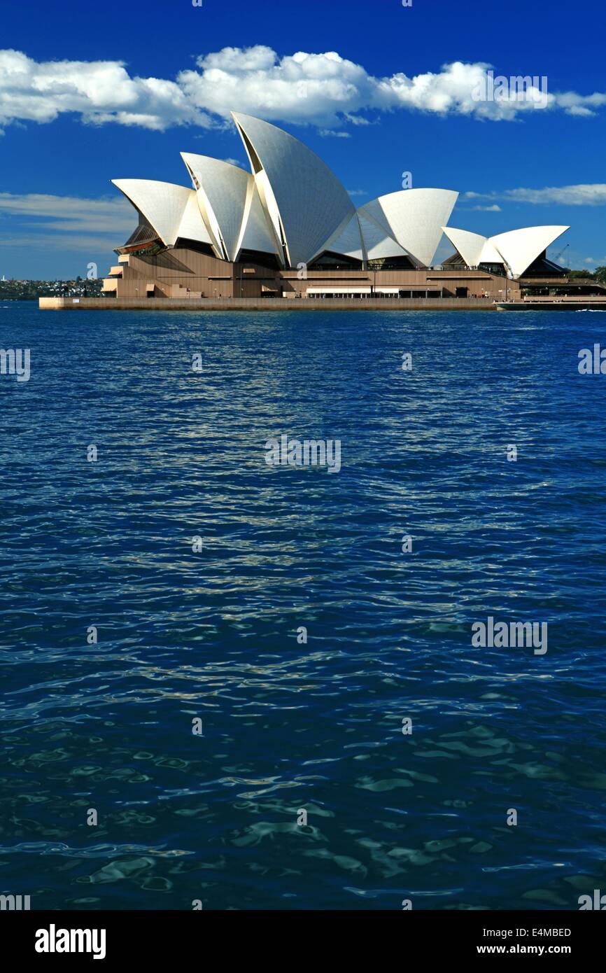 Classic shot of the Sydney Opera House with a blue sky and puffy clouds ...