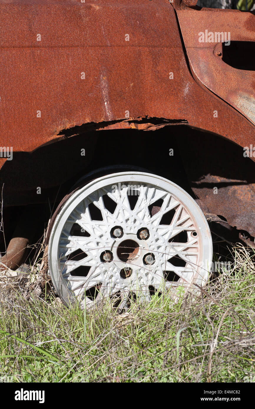 Alloy wheel on a burnt out, dumped and stolen car Stock Photo - Alamy