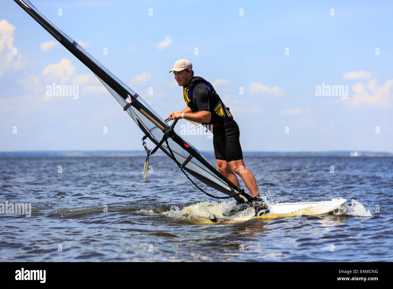 Side view of a windsurfer passing by Stock Photo - Alamy