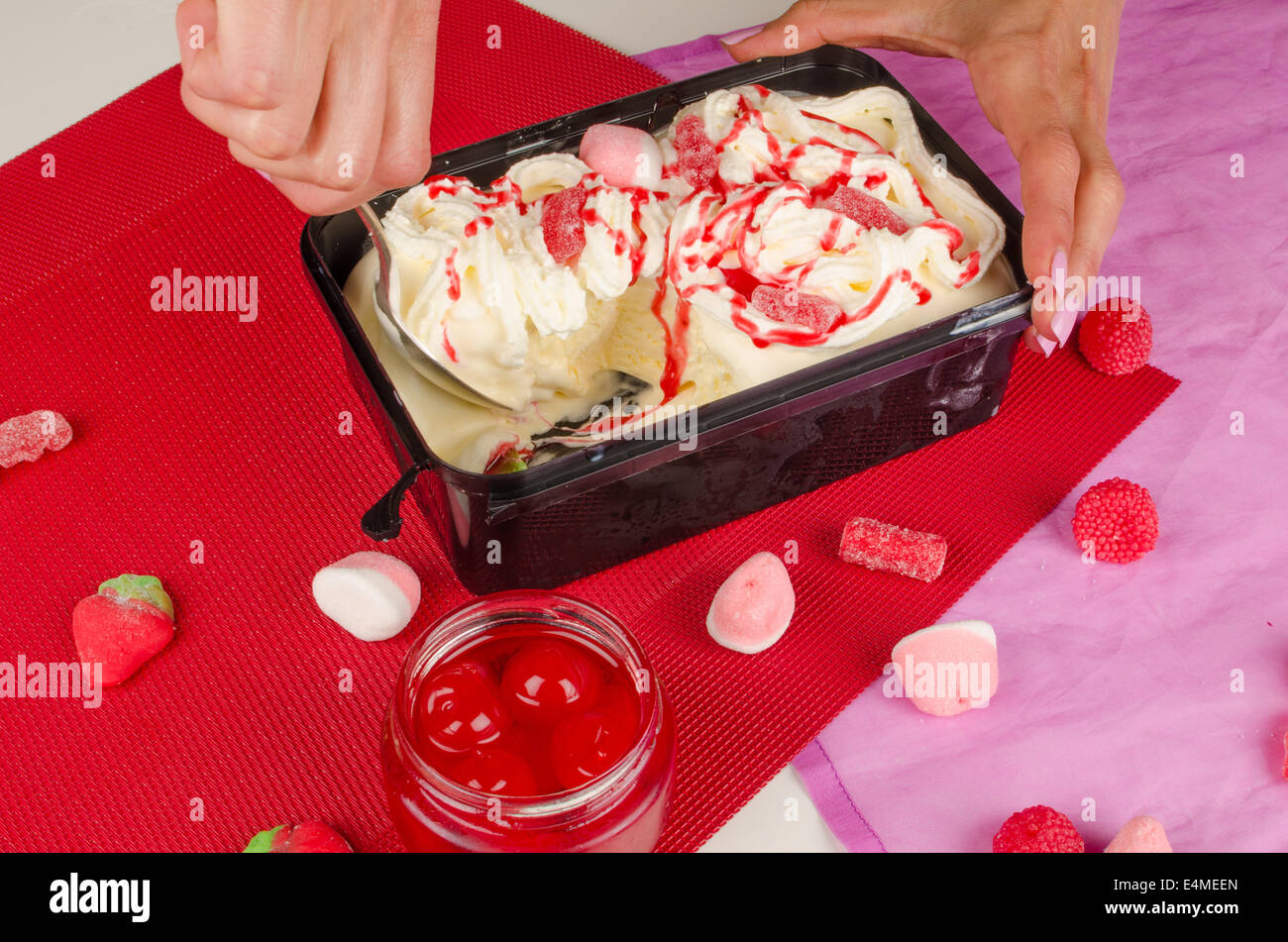 Spoon tucking into a massive portion of cloying ice cream Stock Photo ...