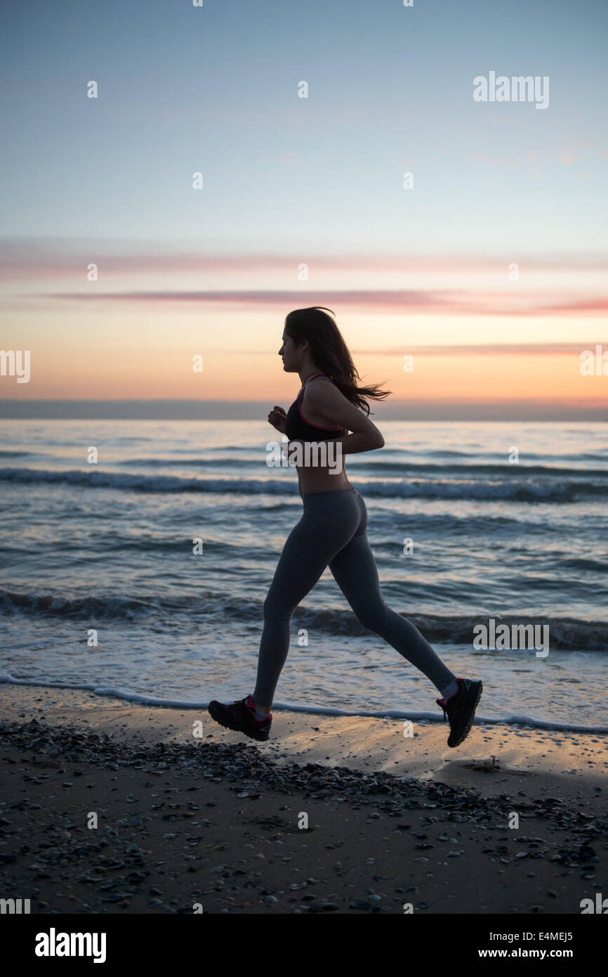 Female running on beach hi-res stock photography and images - Alamy
