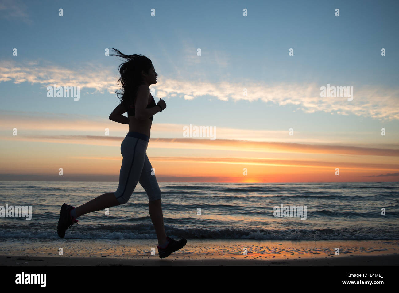 Young Girl Running On The Beach Stock Photo - Alamy