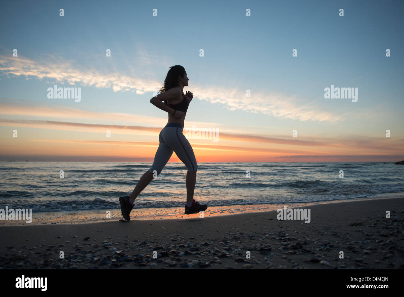Young Girl Running On The Beach Stock Photo - Alamy