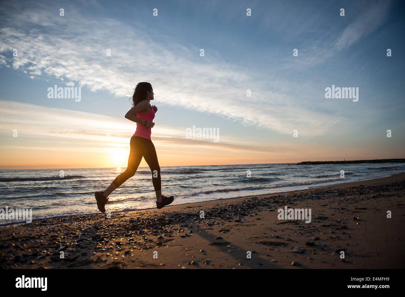 Young Girl Running On The Beach Stock Photo - Alamy