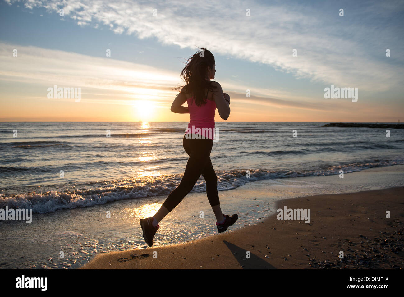 Young Girl Running On The Beach Stock Photo - Alamy