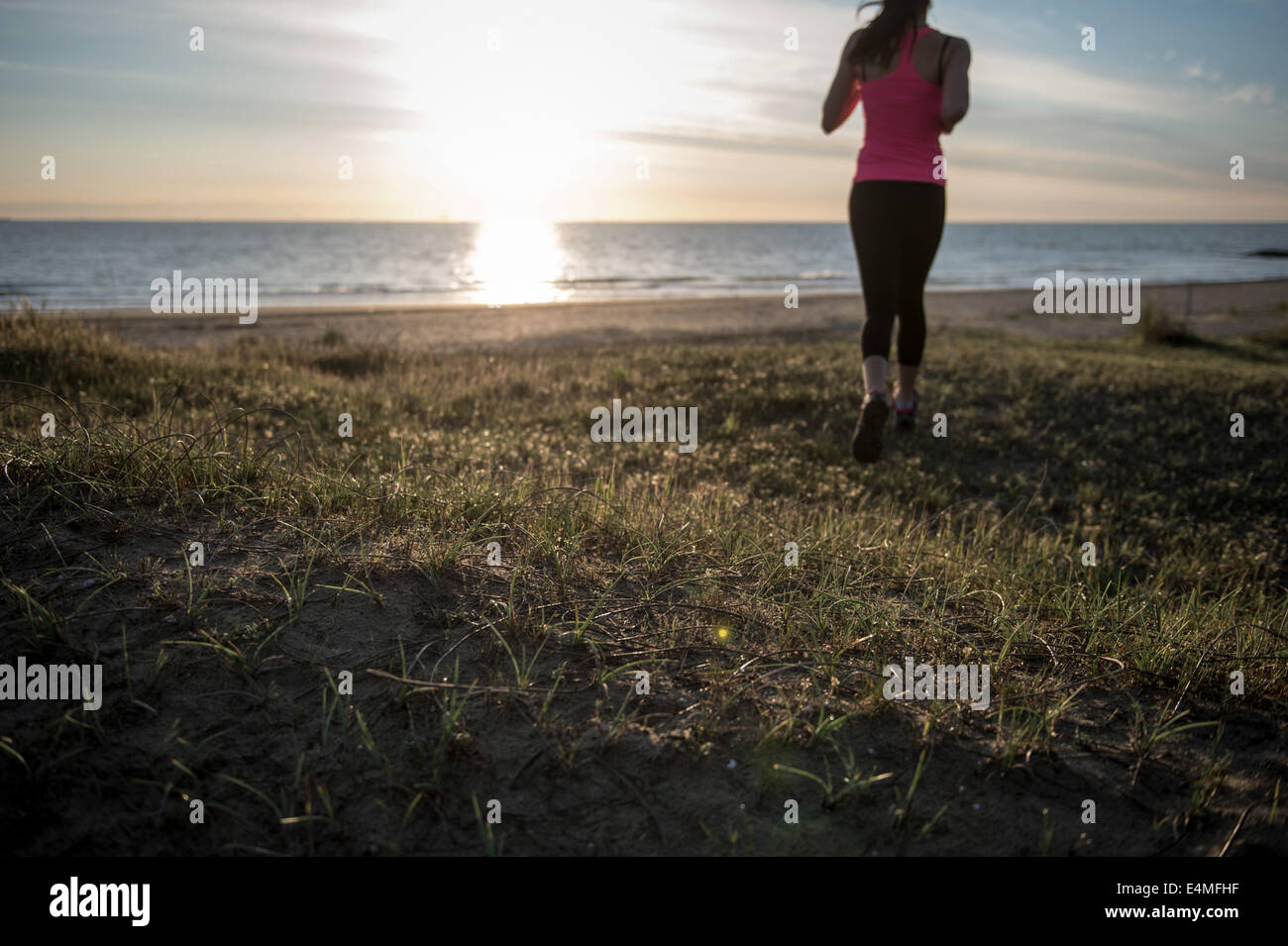 Young Girl Running On The Beach Stock Photo - Alamy
