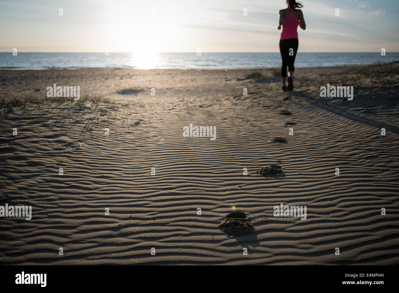 Young Girl Running On The Sand Stock Photo - Alamy