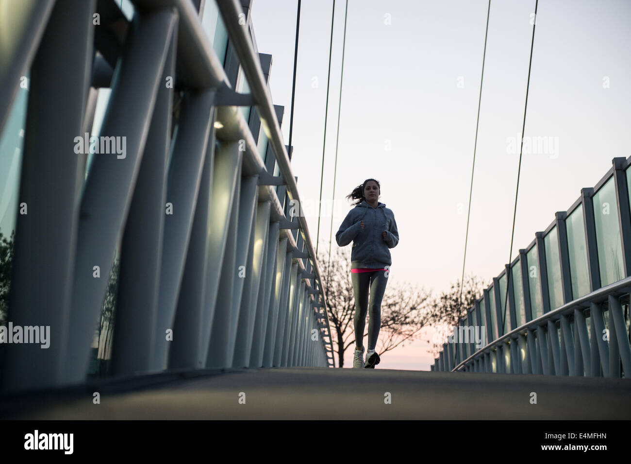 Young Girl Running On A Bridge Stock Photo - Alamy