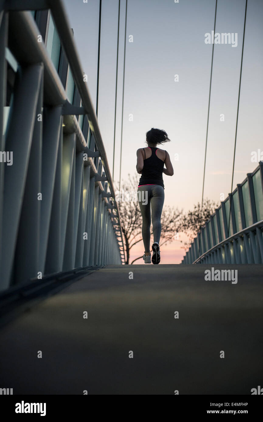 Young Girl Running On A Bridge Stock Photo - Alamy