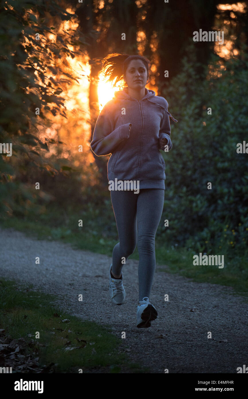 Young Girl Running In A Park Stock Photo - Alamy