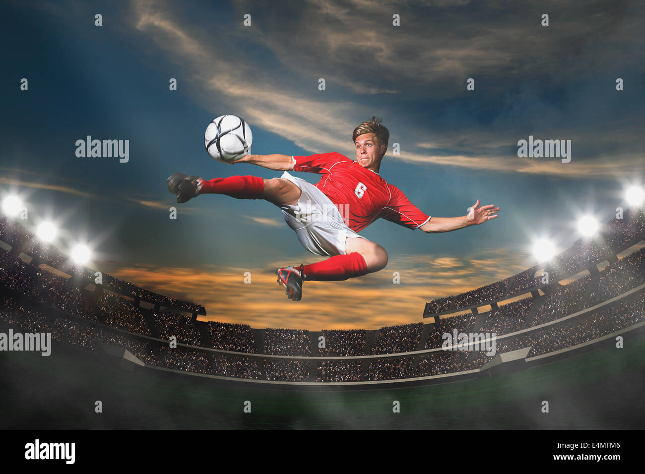 Football player kicking ball sunset hi-res stock photography and images ...