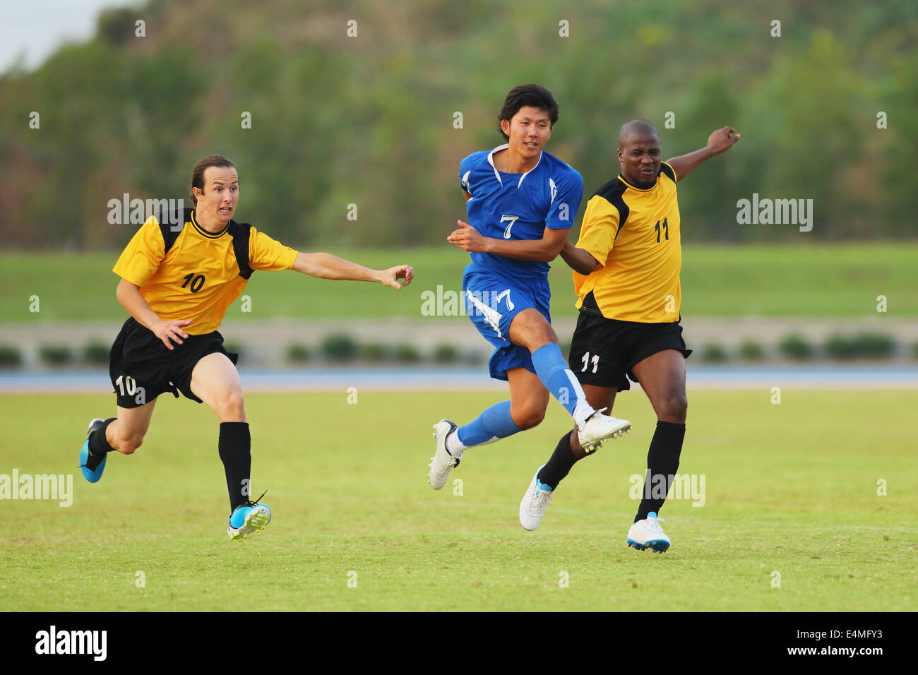 Football players running Stock Photo - Alamy