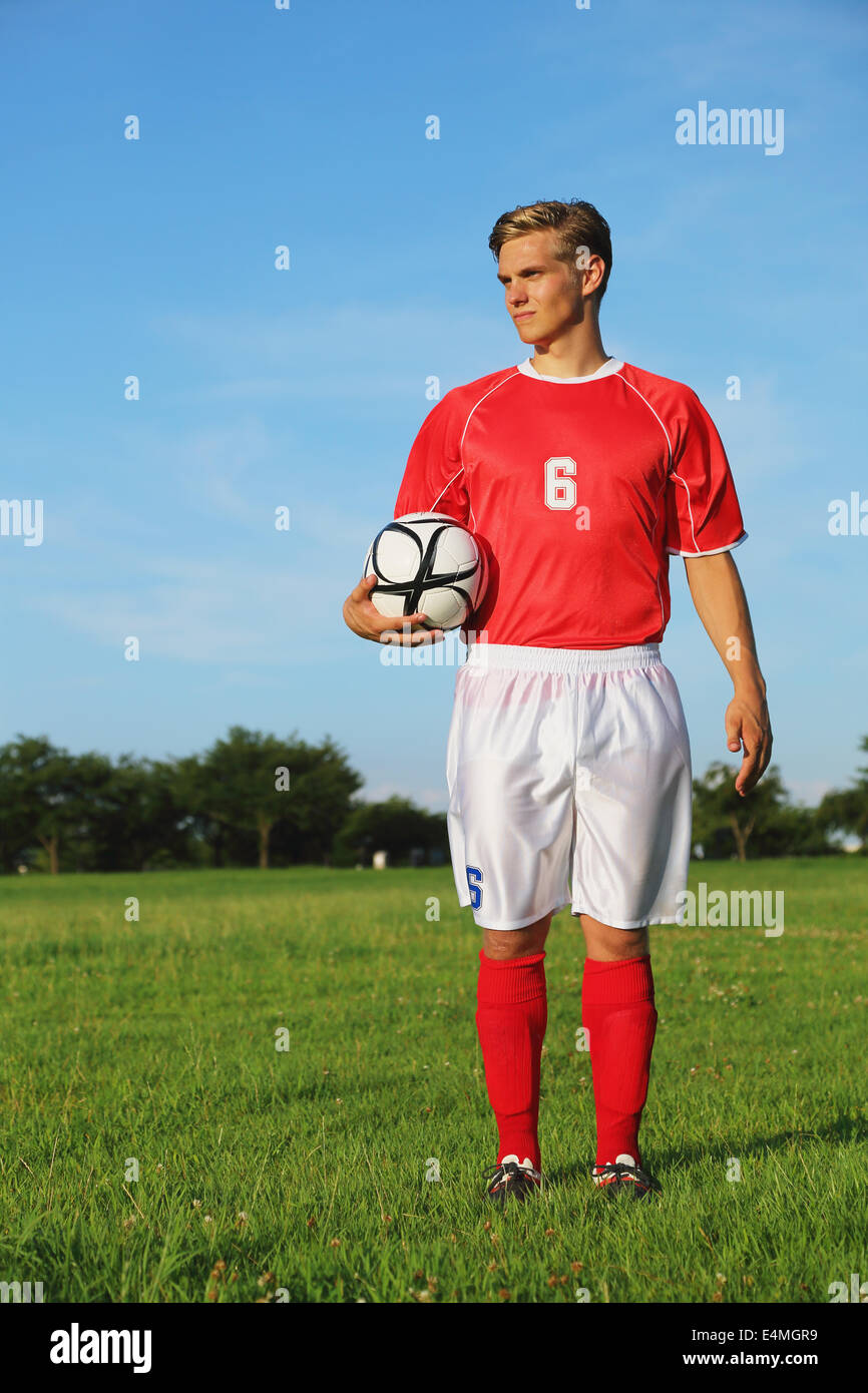 Soccer Player Standing With Ball Stock Photo - Alamy