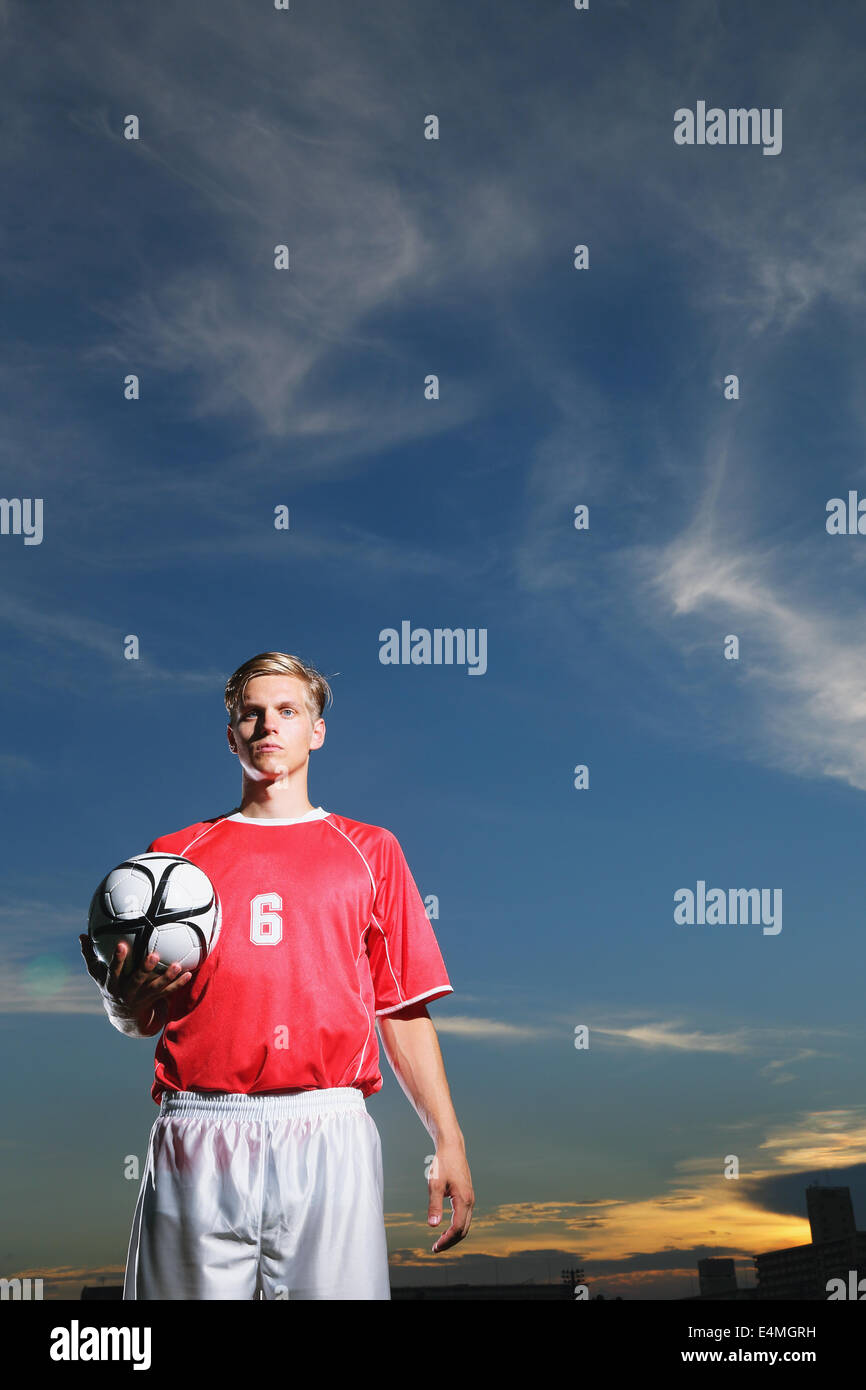 Soccer Player Standing With Ball Stock Photo - Alamy
