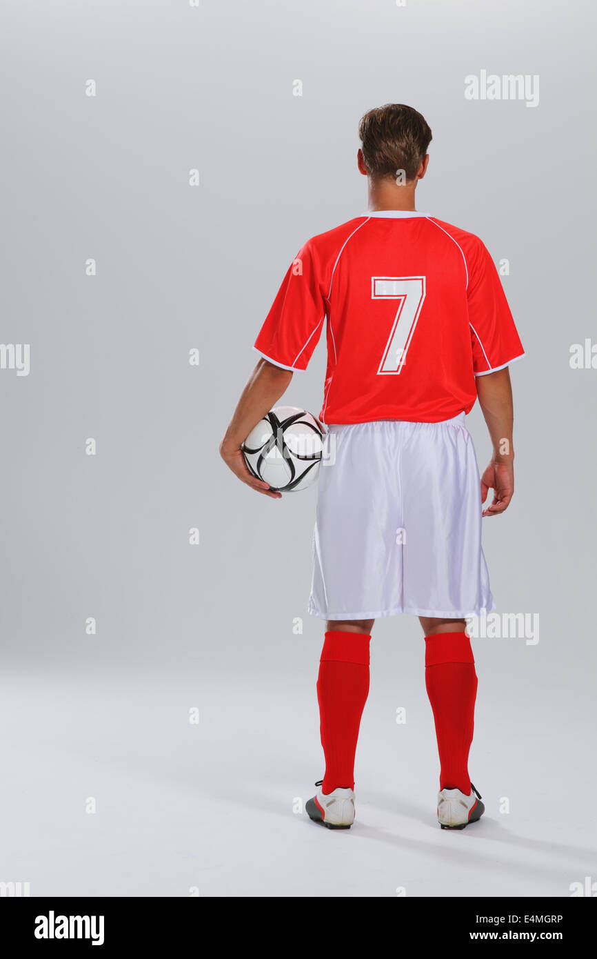 Soccer Player Standing With Ball Stock Photo - Alamy