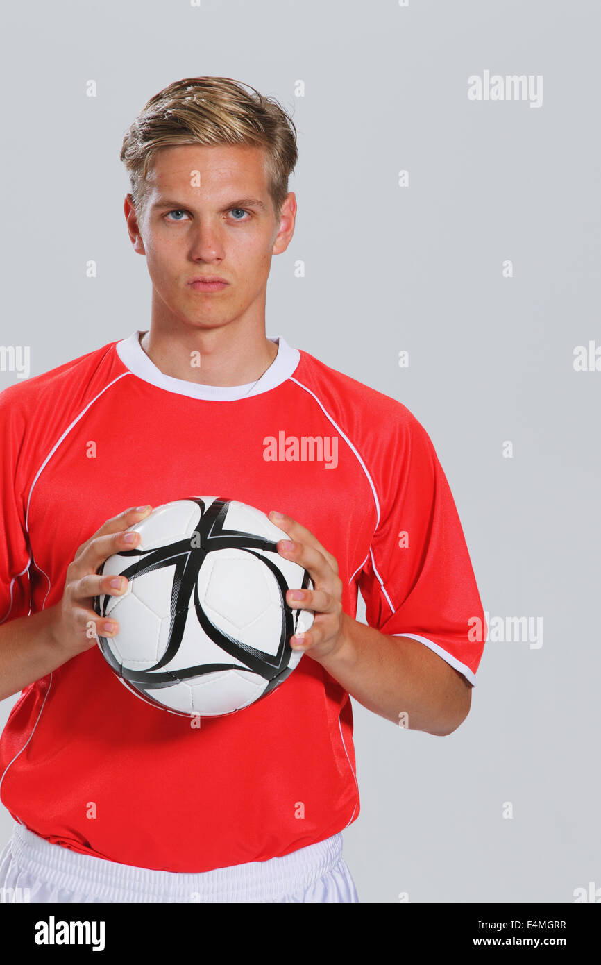 Soccer Player Standing With Ball Stock Photo - Alamy