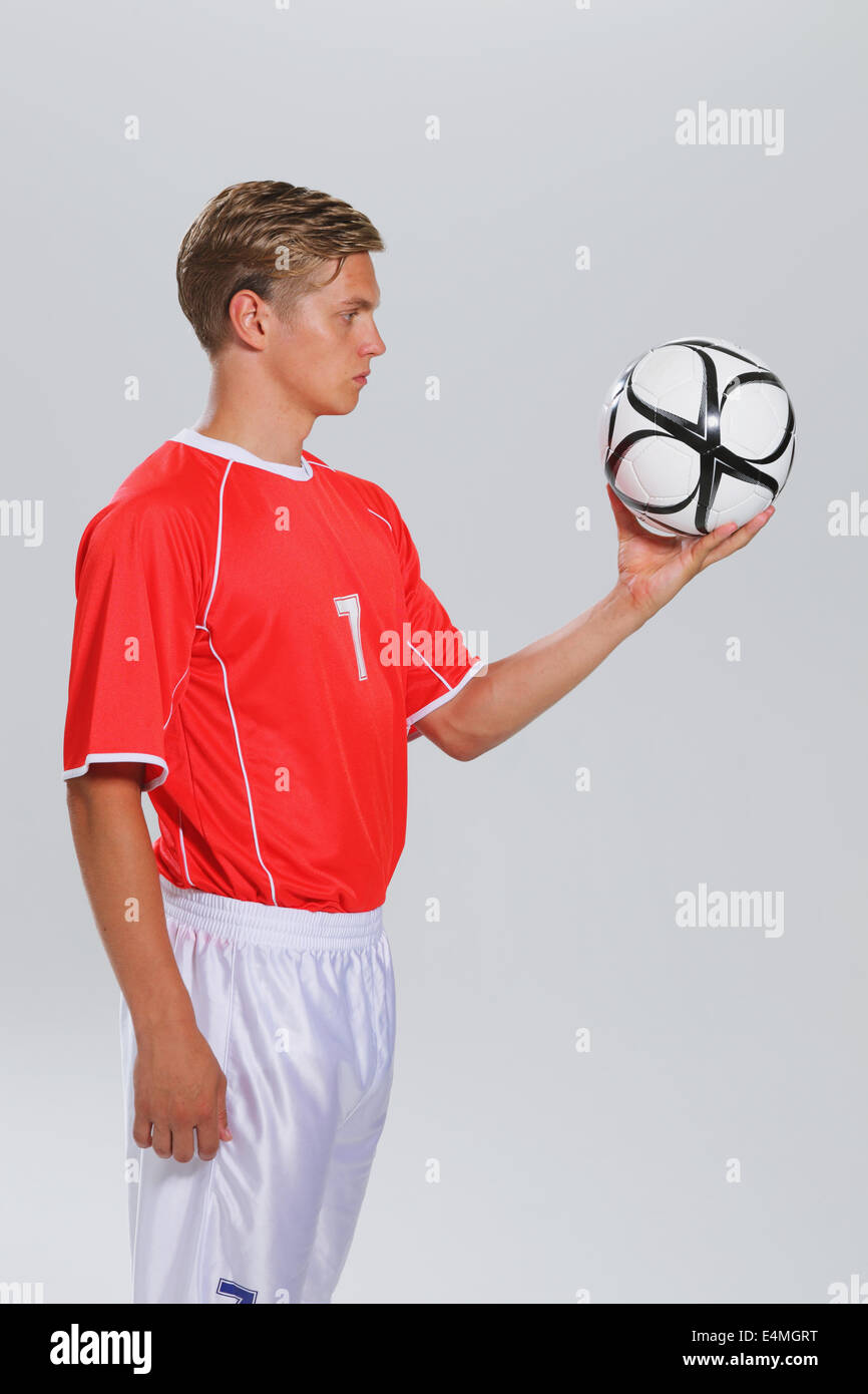 Soccer Player Standing With Ball Stock Photo - Alamy