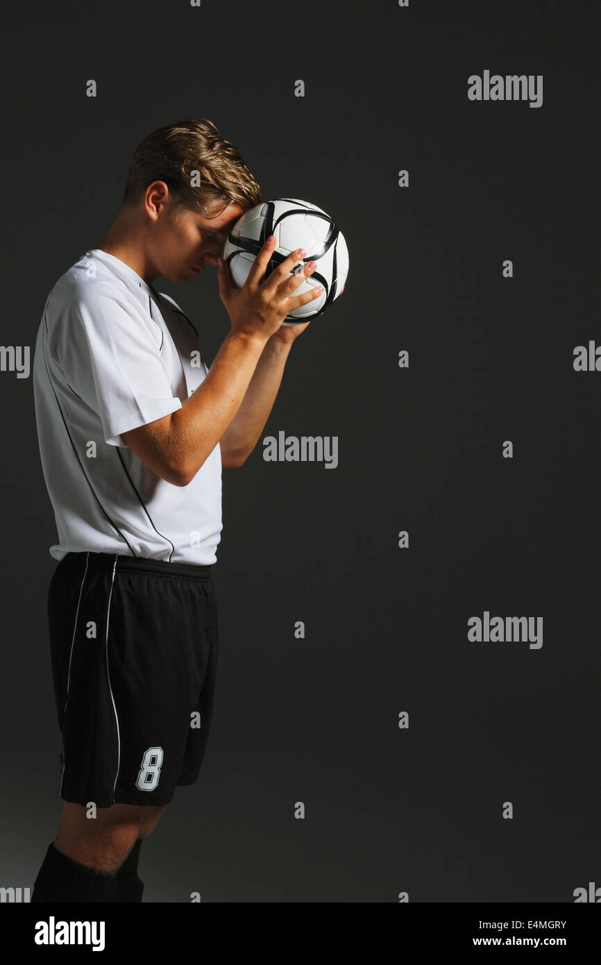 Soccer Player Standing With Ball Stock Photo - Alamy
