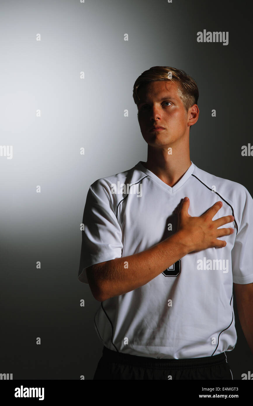 Soccer Player With Hand On Chest Stock Photo - Alamy