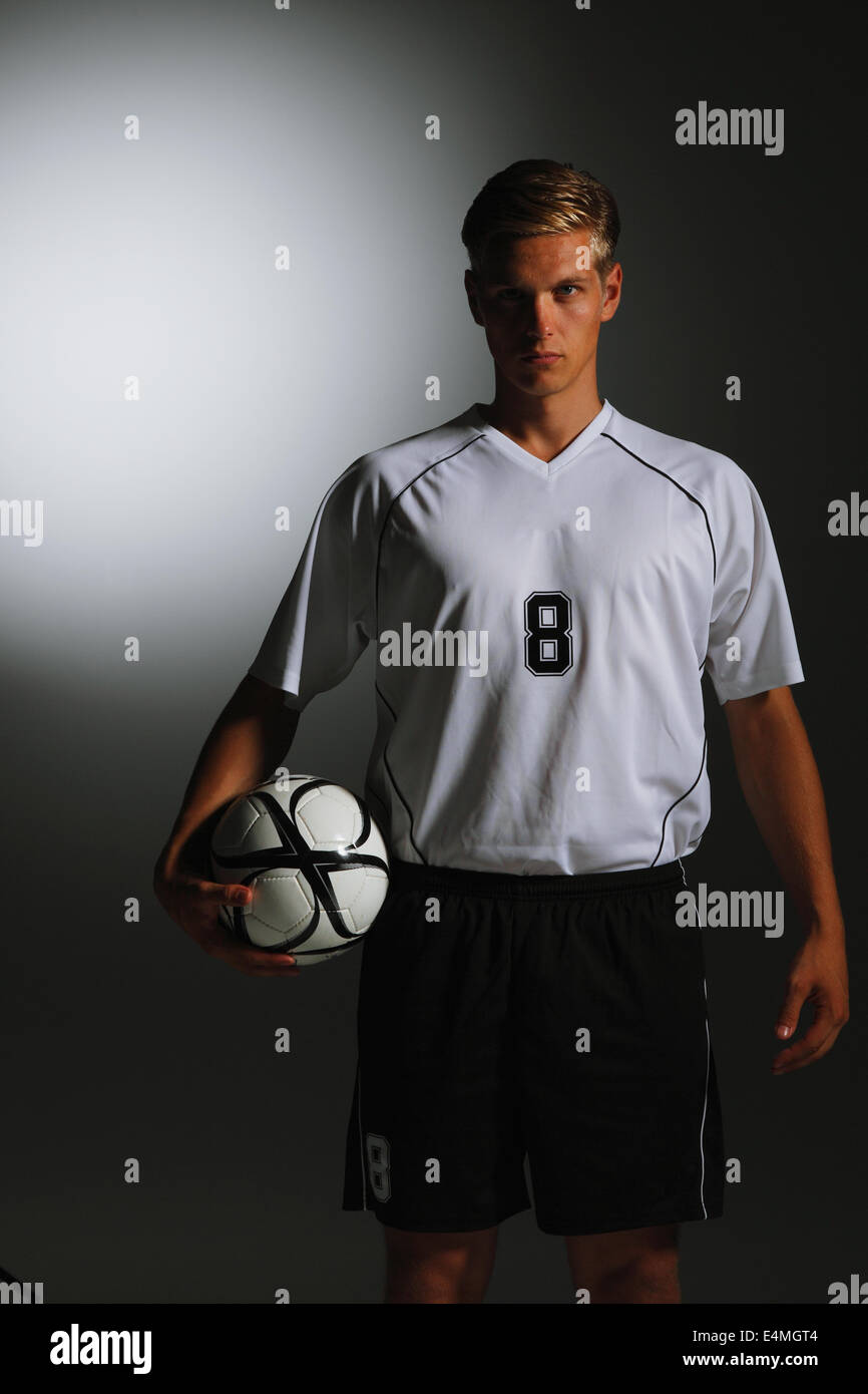 Soccer Player Standing With Ball Stock Photo - Alamy