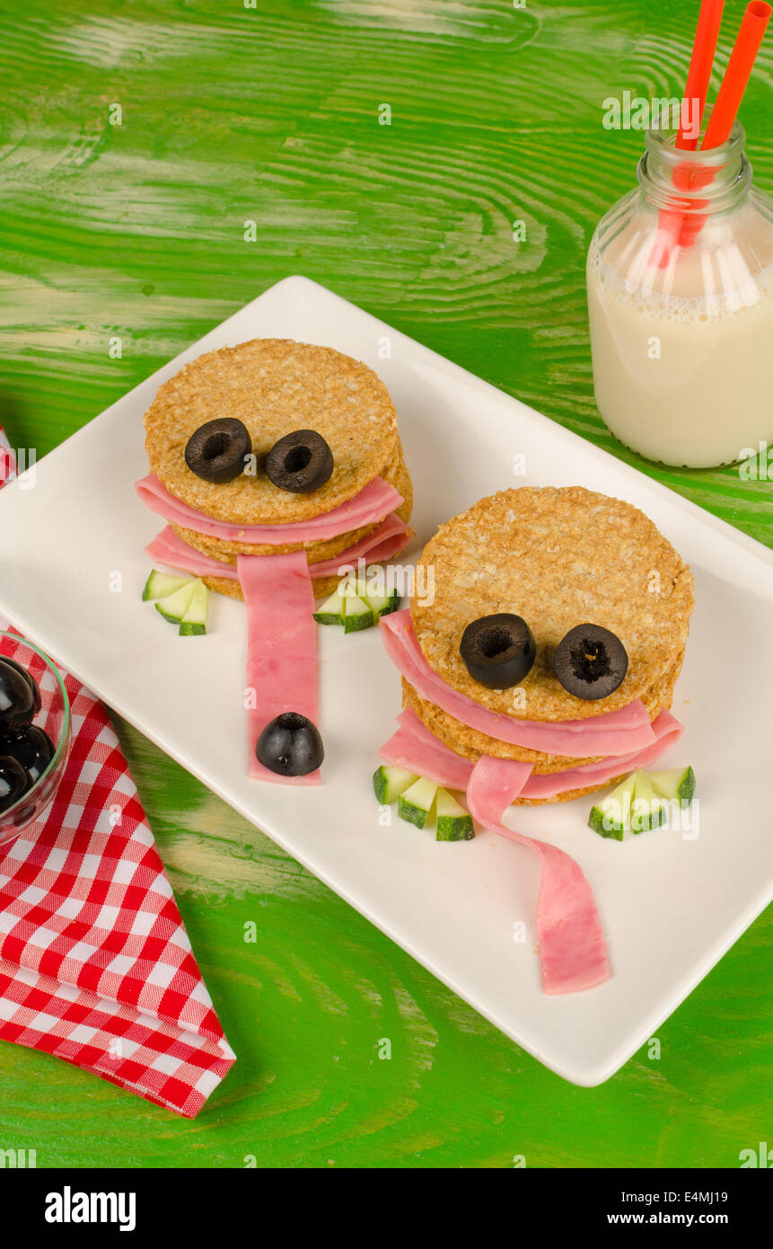 Crunchy crackers resembling faces, a funny kid snack Stock Photo - Alamy