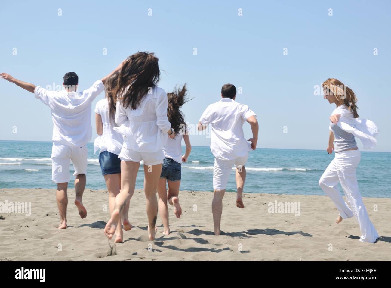 happy people group have fun and running on beach Stock Photo - Alamy