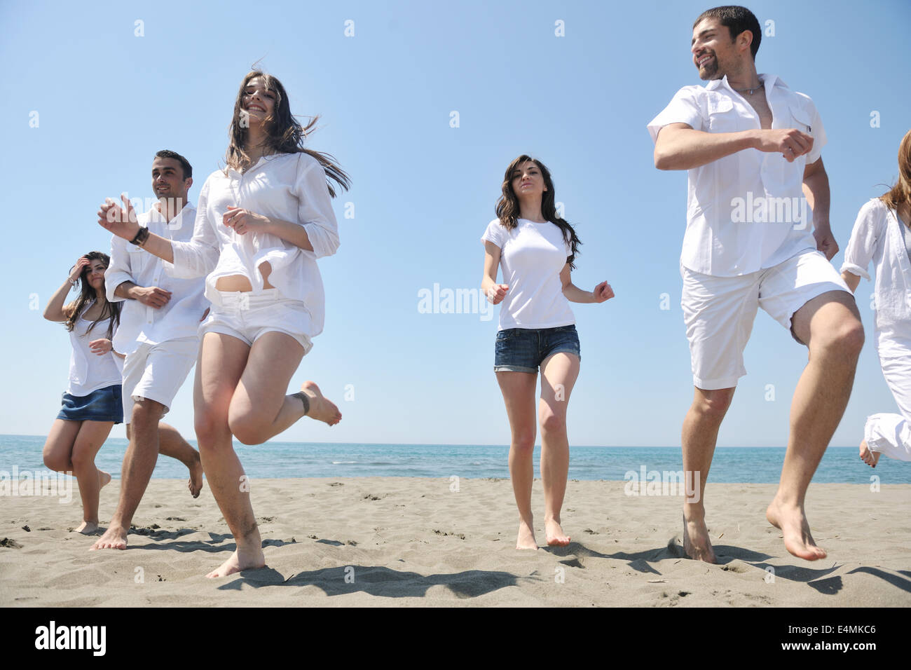 happy people group have fun and running on beach Stock Photo - Alamy