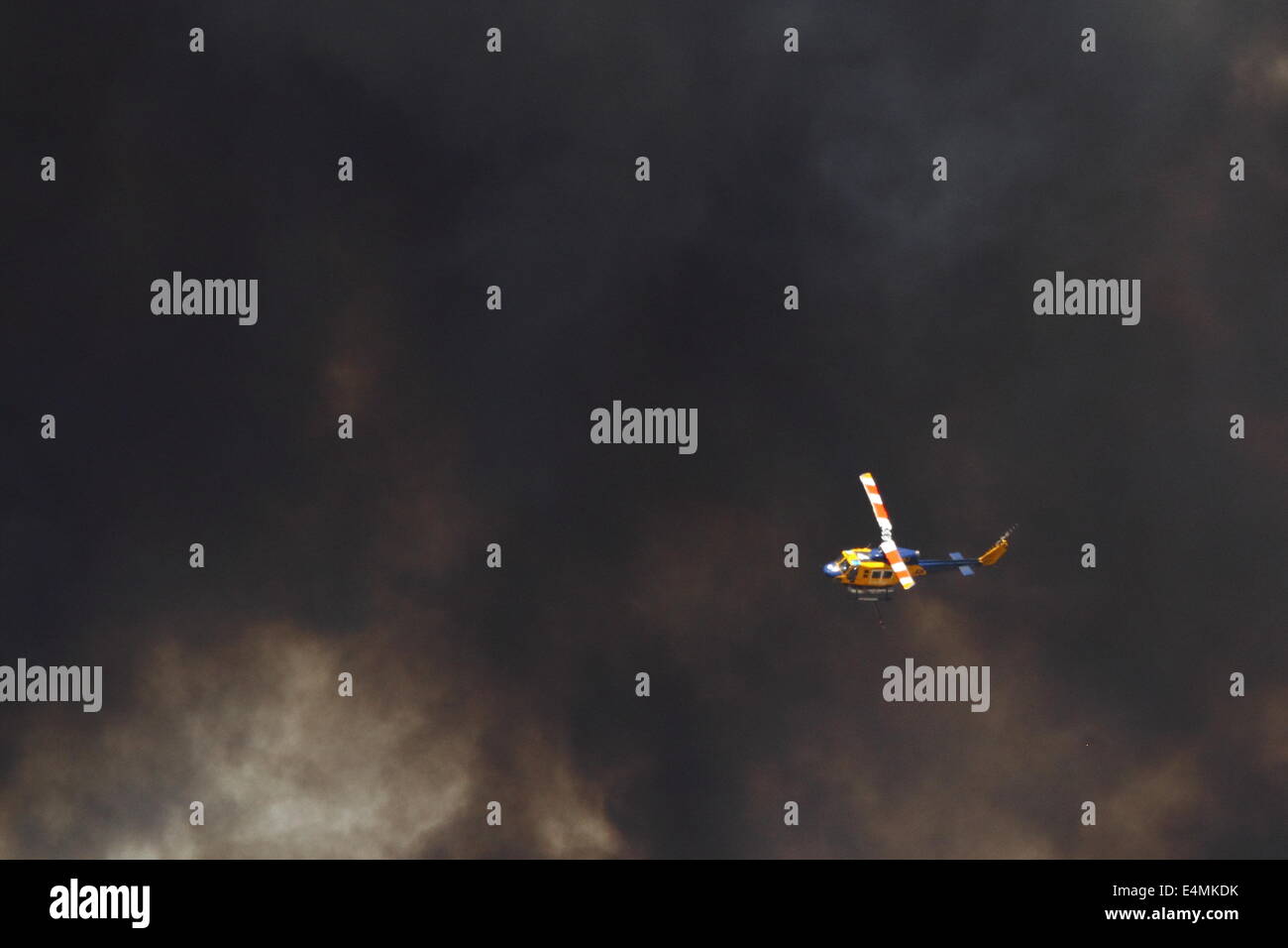 Aerial fire fighting a bush fire using water bomber helicopter in ...