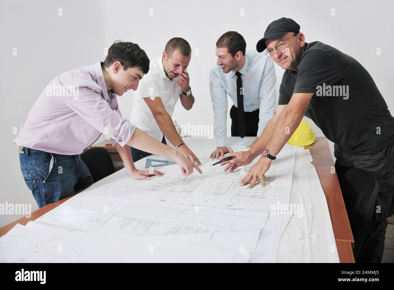 Team of architects on construciton site Stock Photo - Alamy