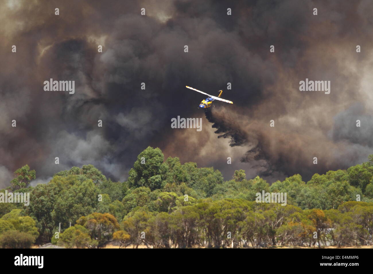 Aerial fire fighting a bush fire using water bomber helicopter in Banjup, Western Australia ...
