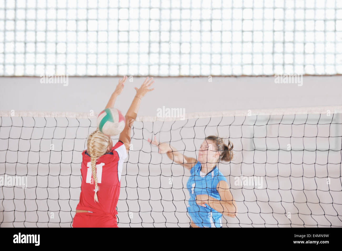 girls playing volleyball indoor game Stock Photo - Alamy