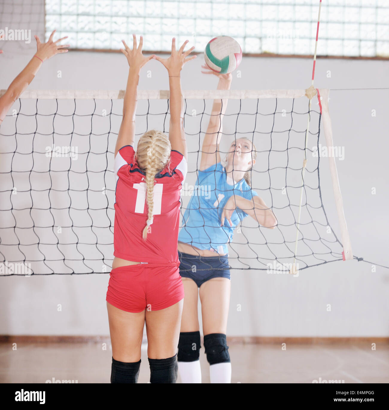 girls playing volleyball indoor game Stock Photo - Alamy