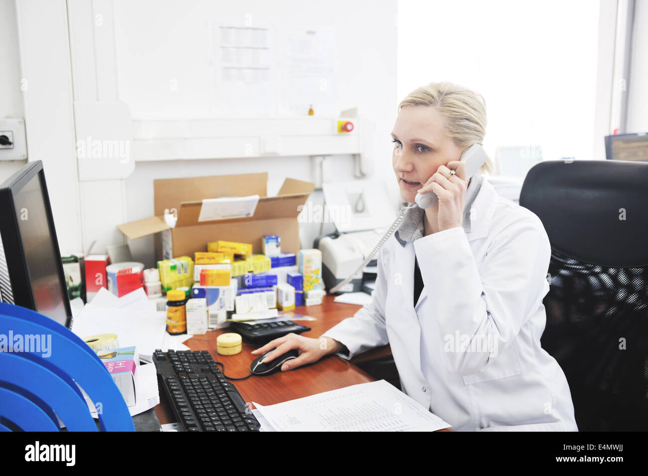 pharmacy worker talking by phone Stock Photo - Alamy