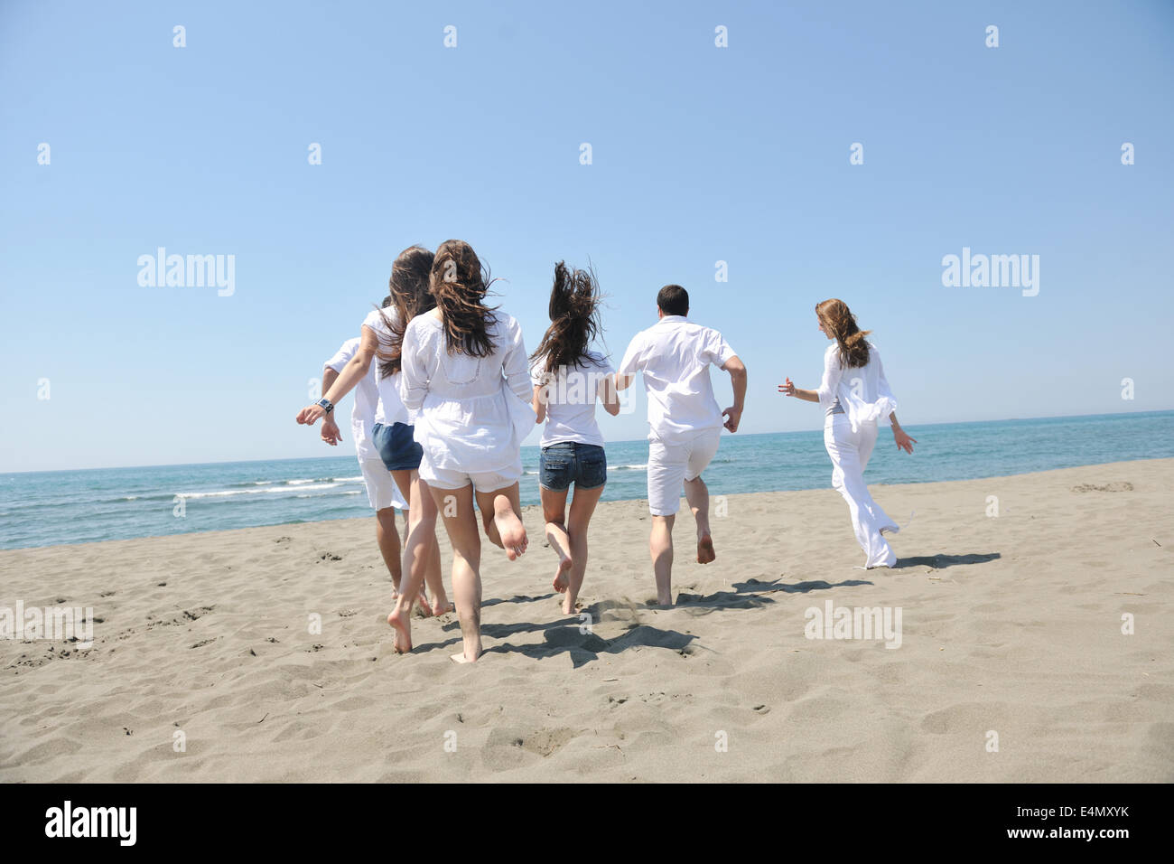 happy people group have fun and running on beach Stock Photo - Alamy