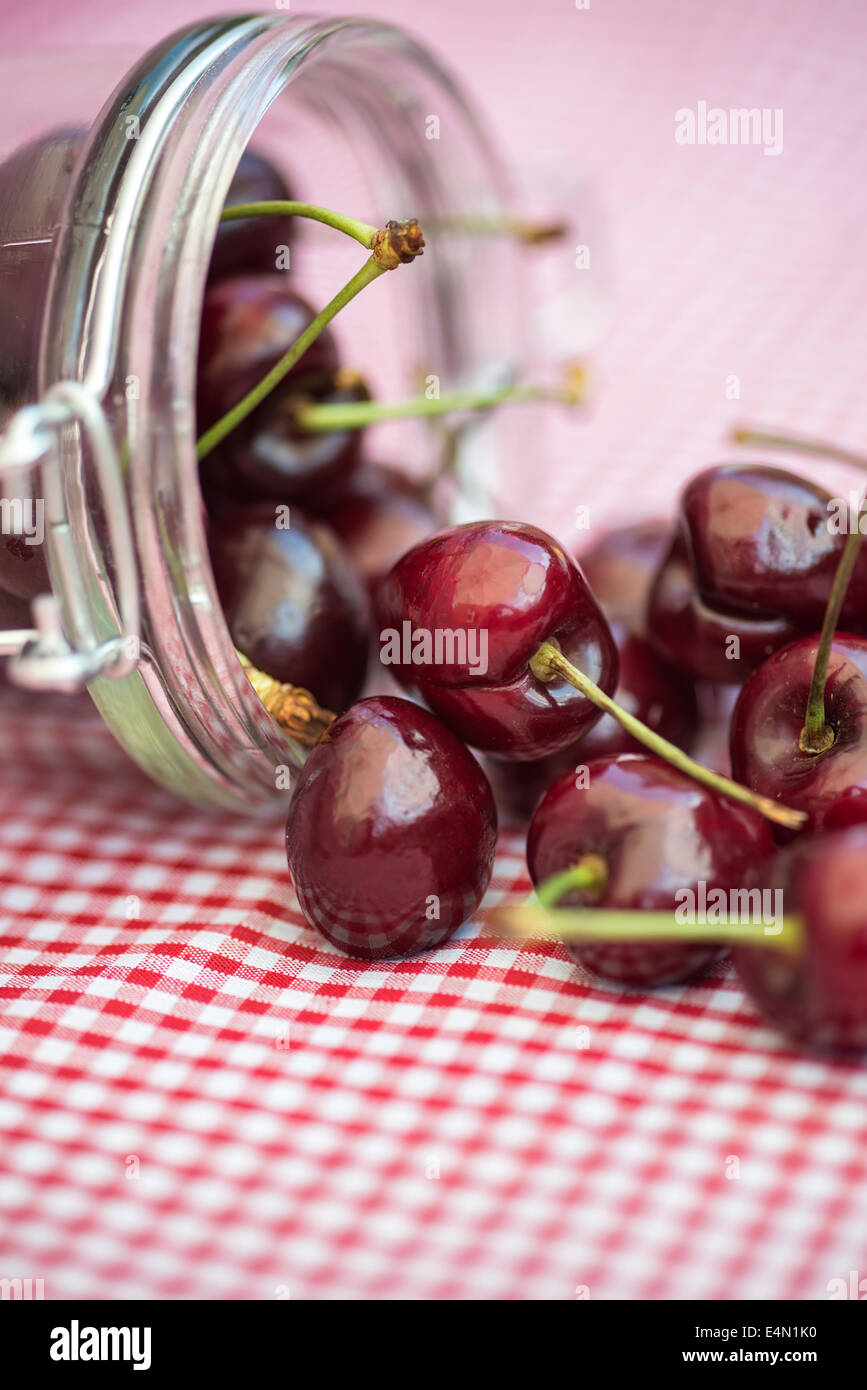 Fresh tasty cherries in glass storage jar Stock Photo - Alamy