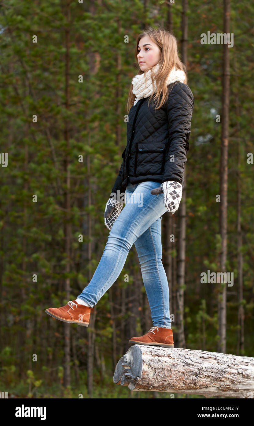 A beautiful girl goes to log Stock Photo - Alamy