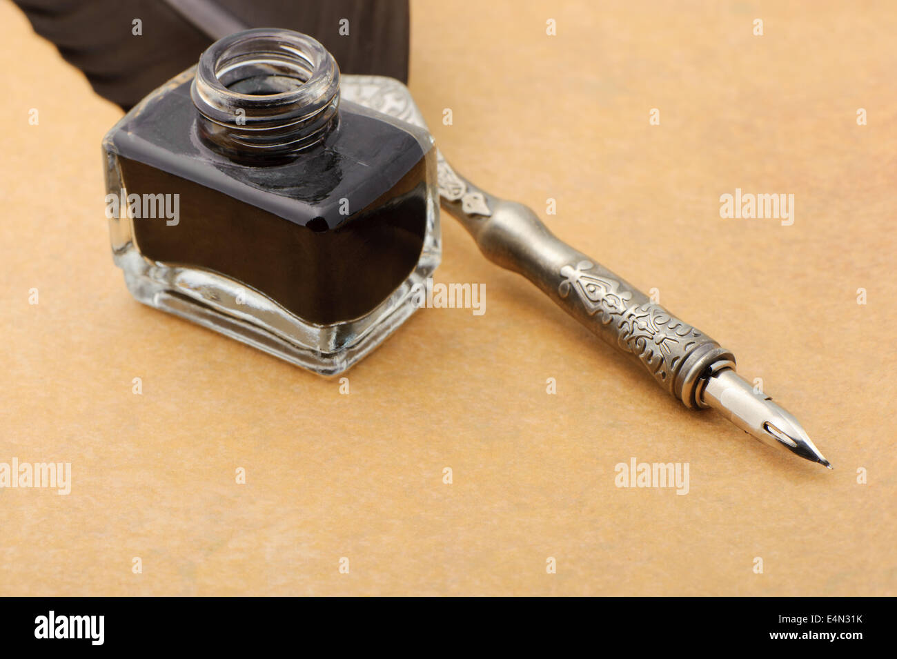 Feather quill and inkwell on an old paper Stock Photo - Alamy