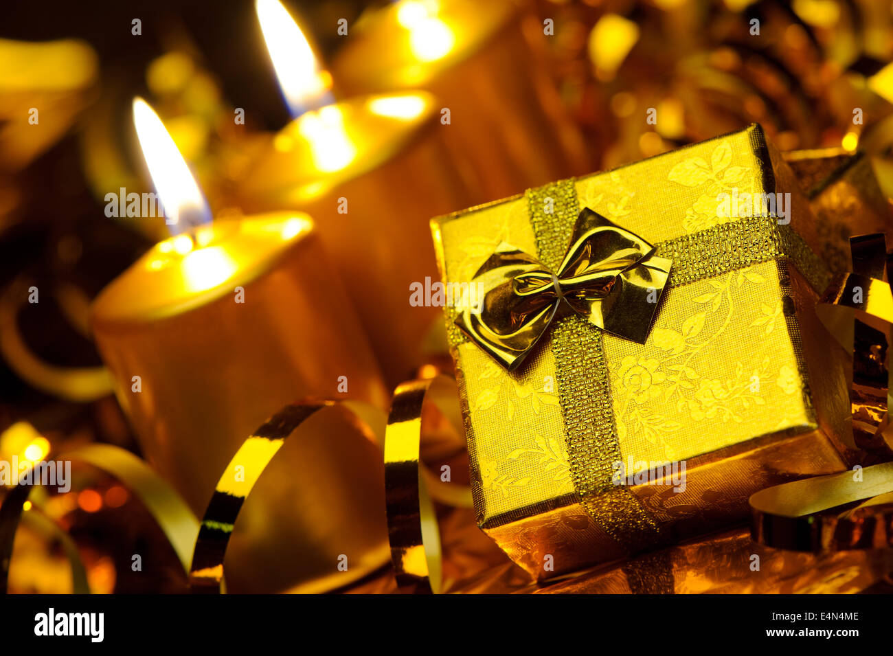 Gold christmas candles and gold gift boxes Stock Photo - Alamy