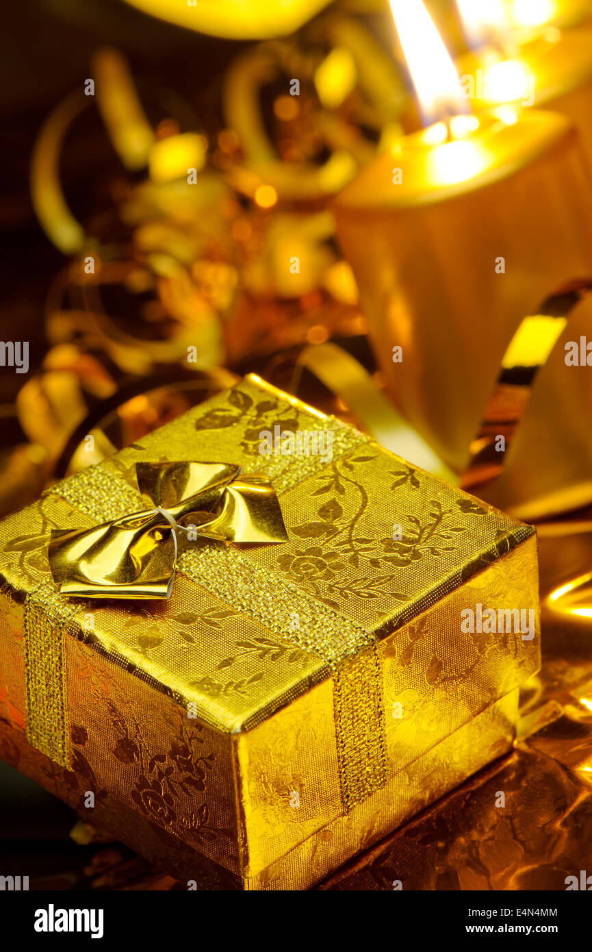 Gold christmas candles and gold gift boxes Stock Photo - Alamy